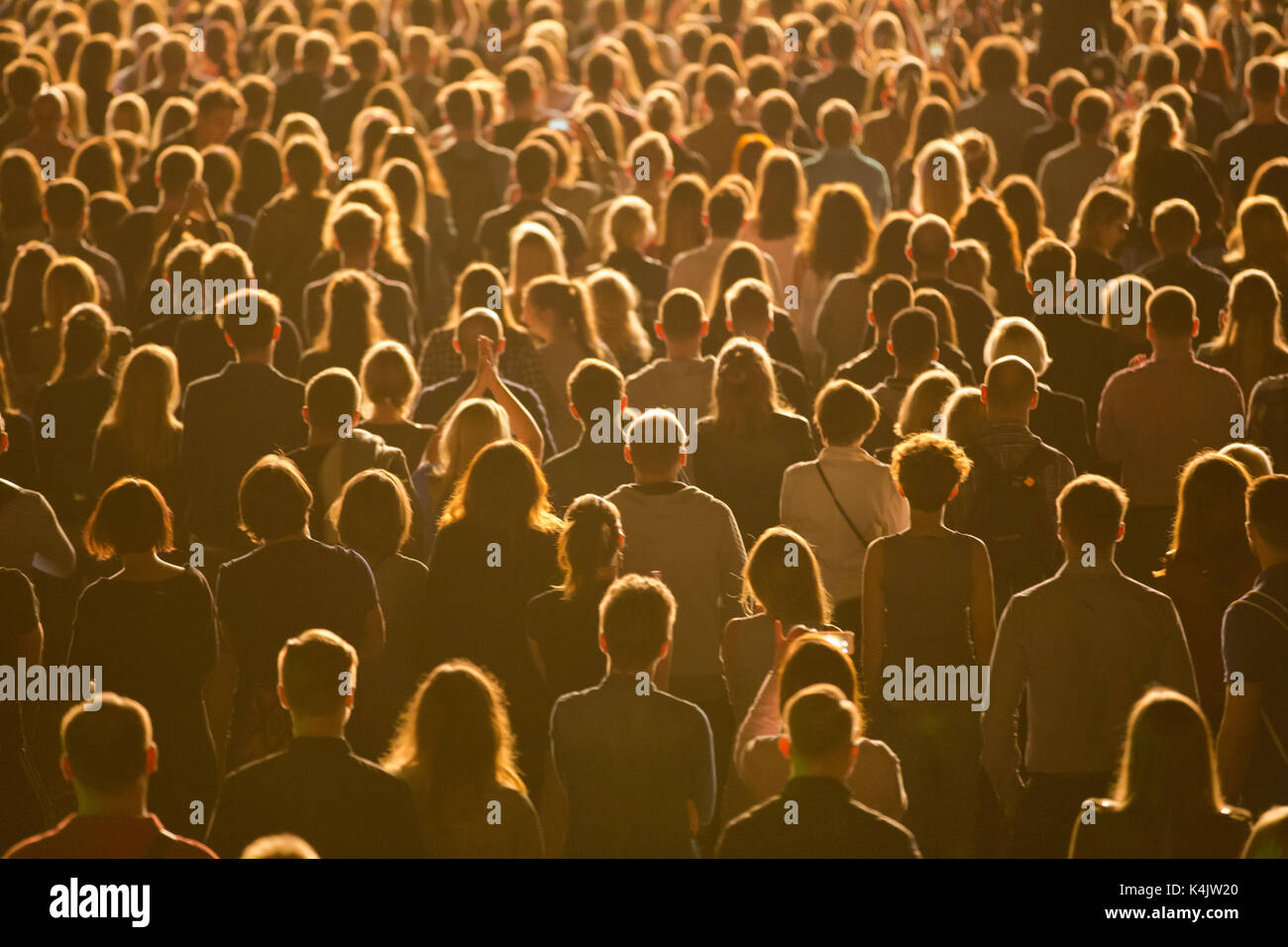 Anonymous crowd of people standing during mass event Stock Photo - Alamy
