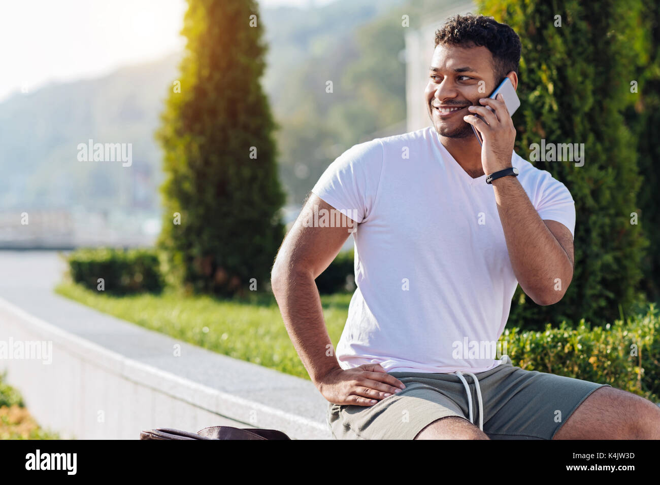 Positive delighted foreign man using telephone Stock Photo - Alamy