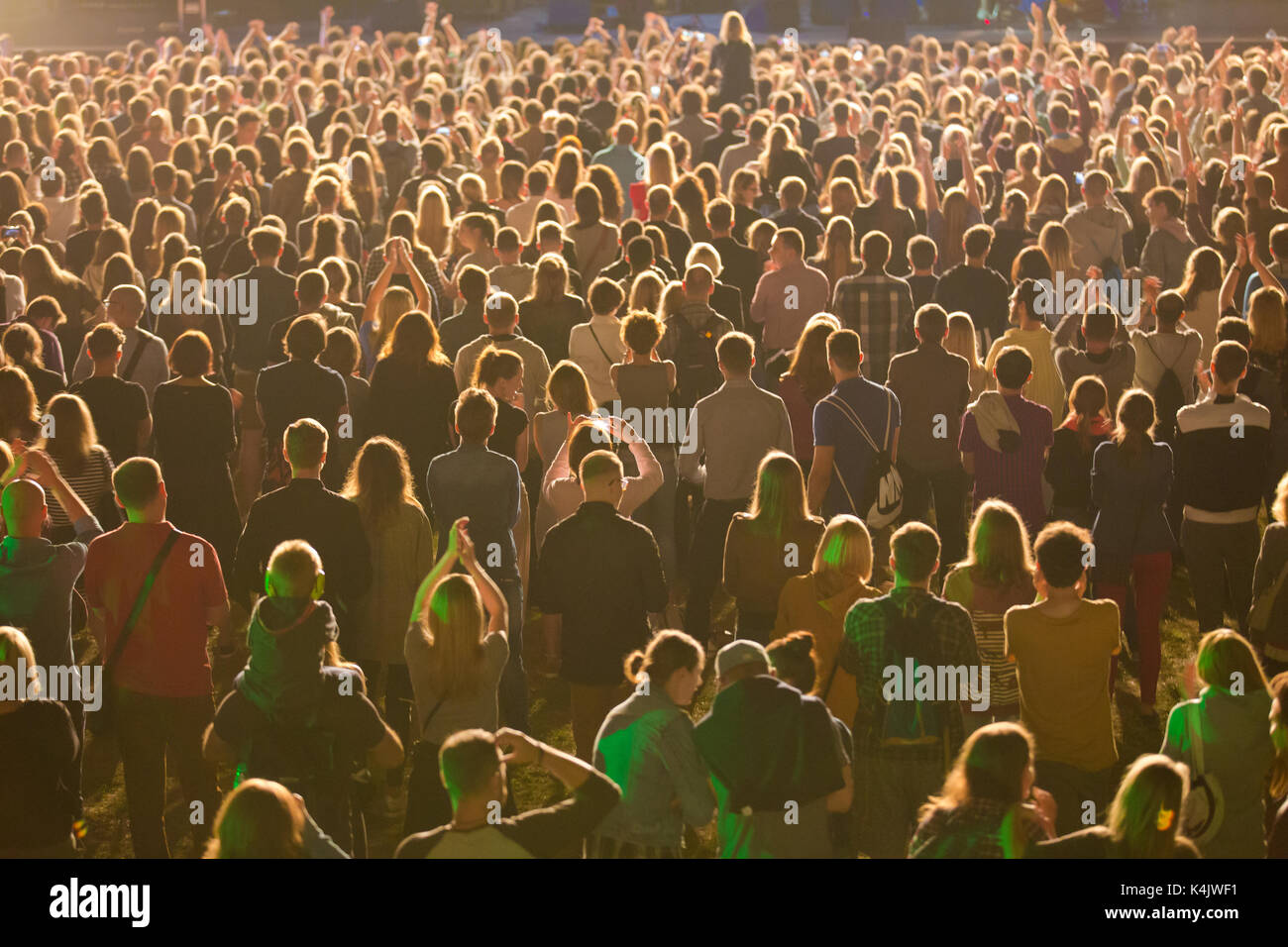 Anonymous crowd of people standing during mass event Stock Photo - Alamy