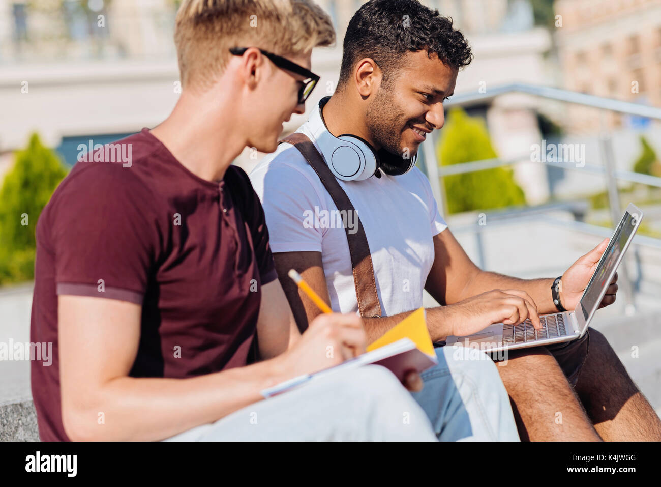 Positive foreign student working with his partner Stock Photo - Alamy