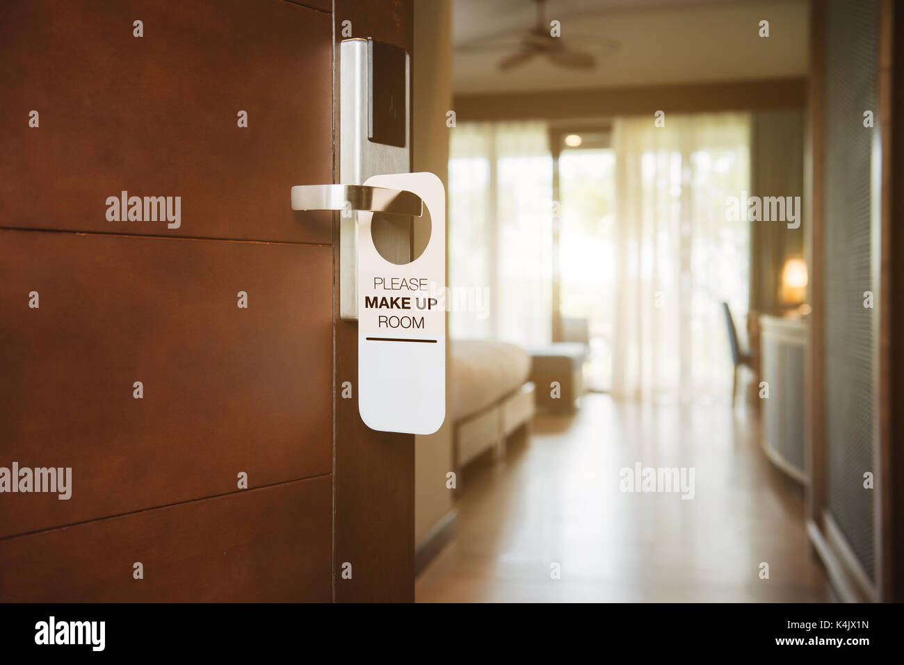 The hotel room with PLEASE MAKE UP ROOM sign on the door Stock Photo ...