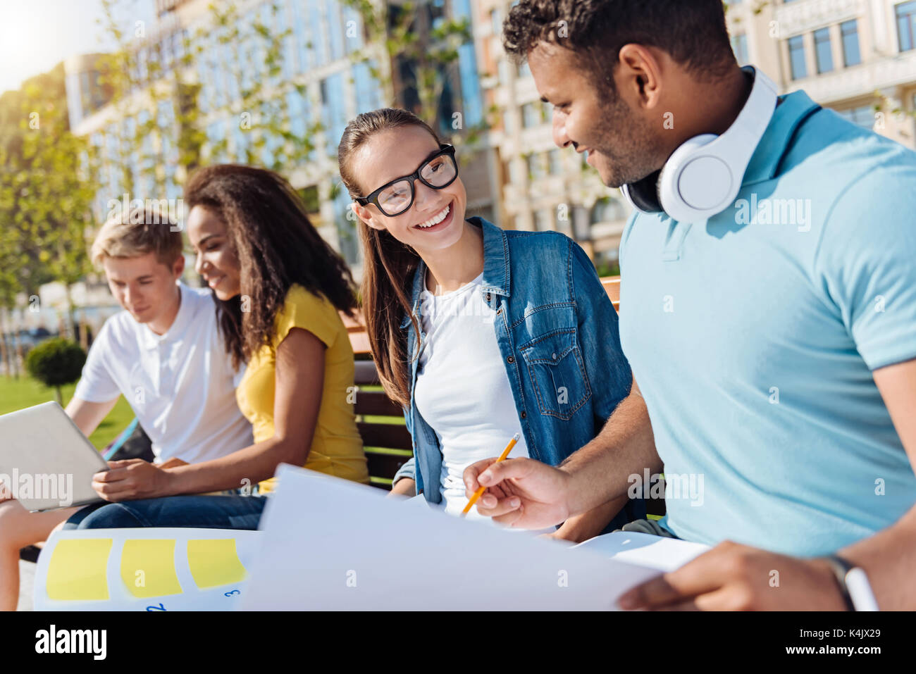Positive girl looking at her clever friend Stock Photo - Alamy
