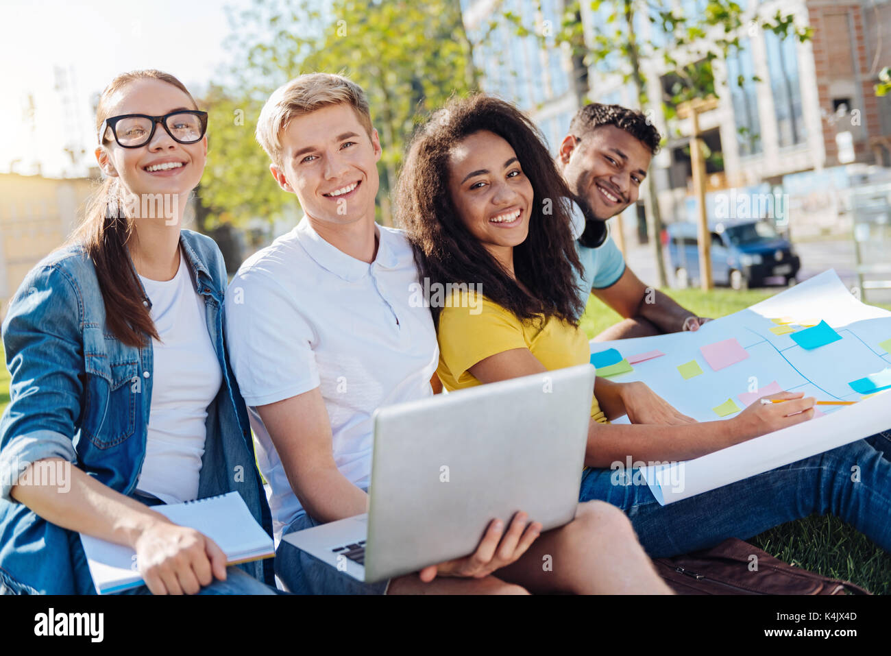 Positive delighted group mates happy working together Stock Photo - Alamy