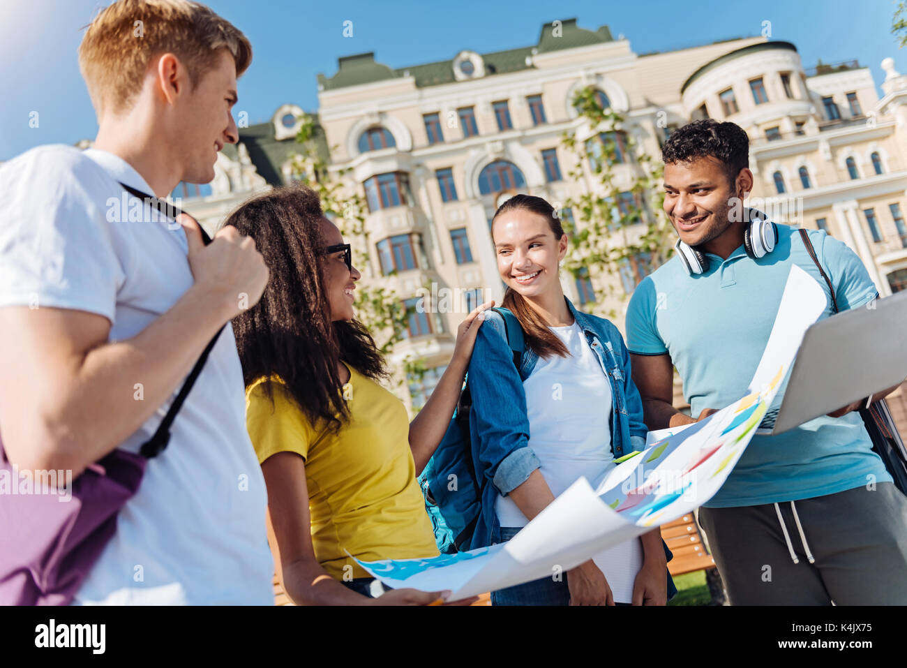 Positive delighted students discussing their work Stock Photo - Alamy