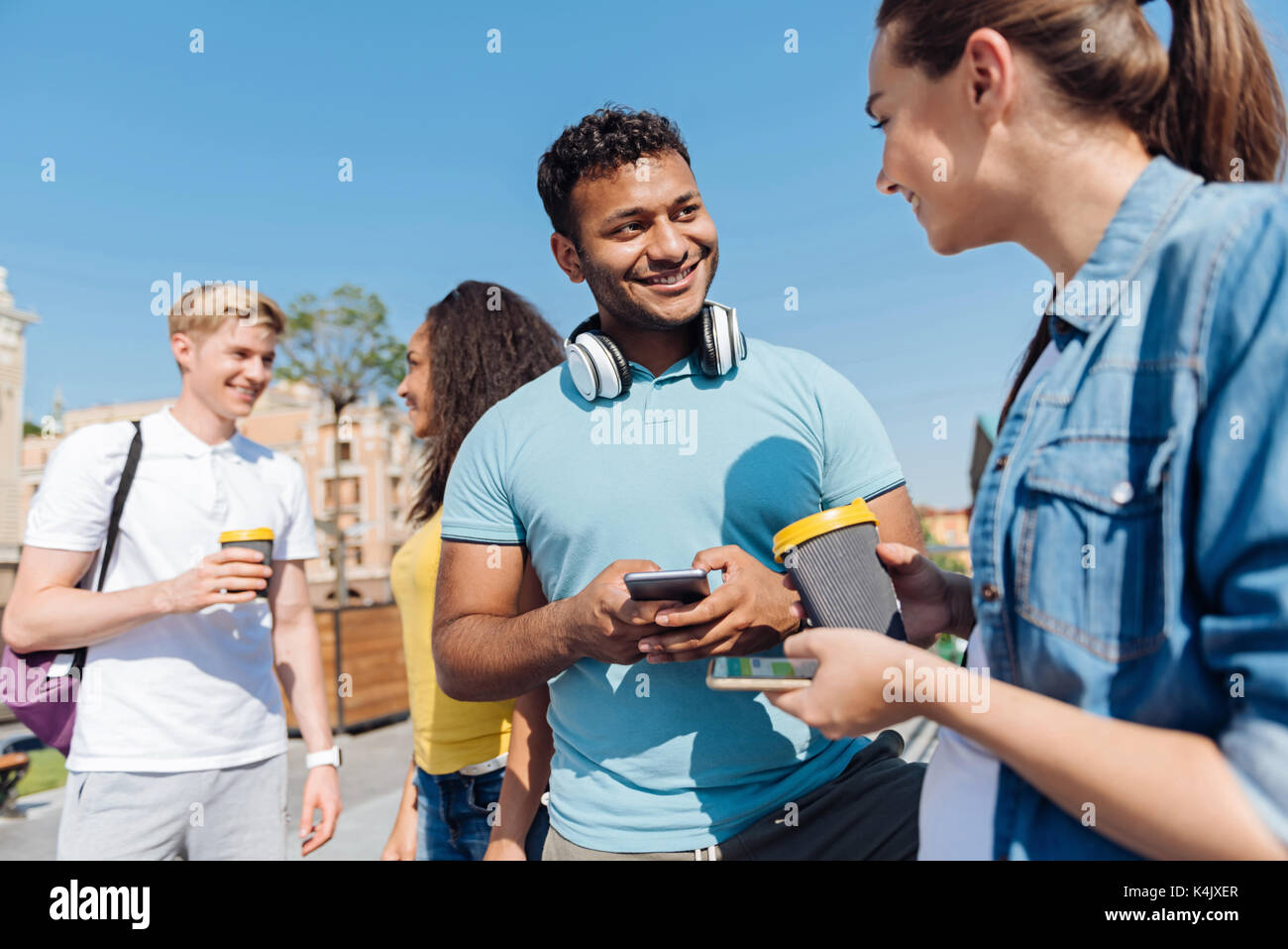 Delighted foreign man talking to his group mate Stock Photo - Alamy
