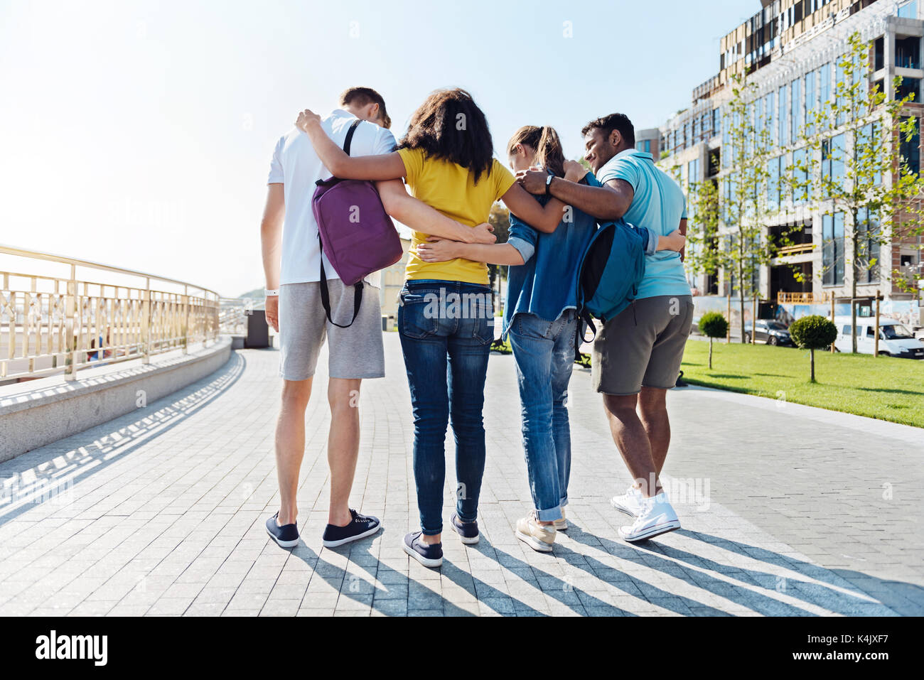 Group of friendly students walking through the pass Stock Photo - Alamy