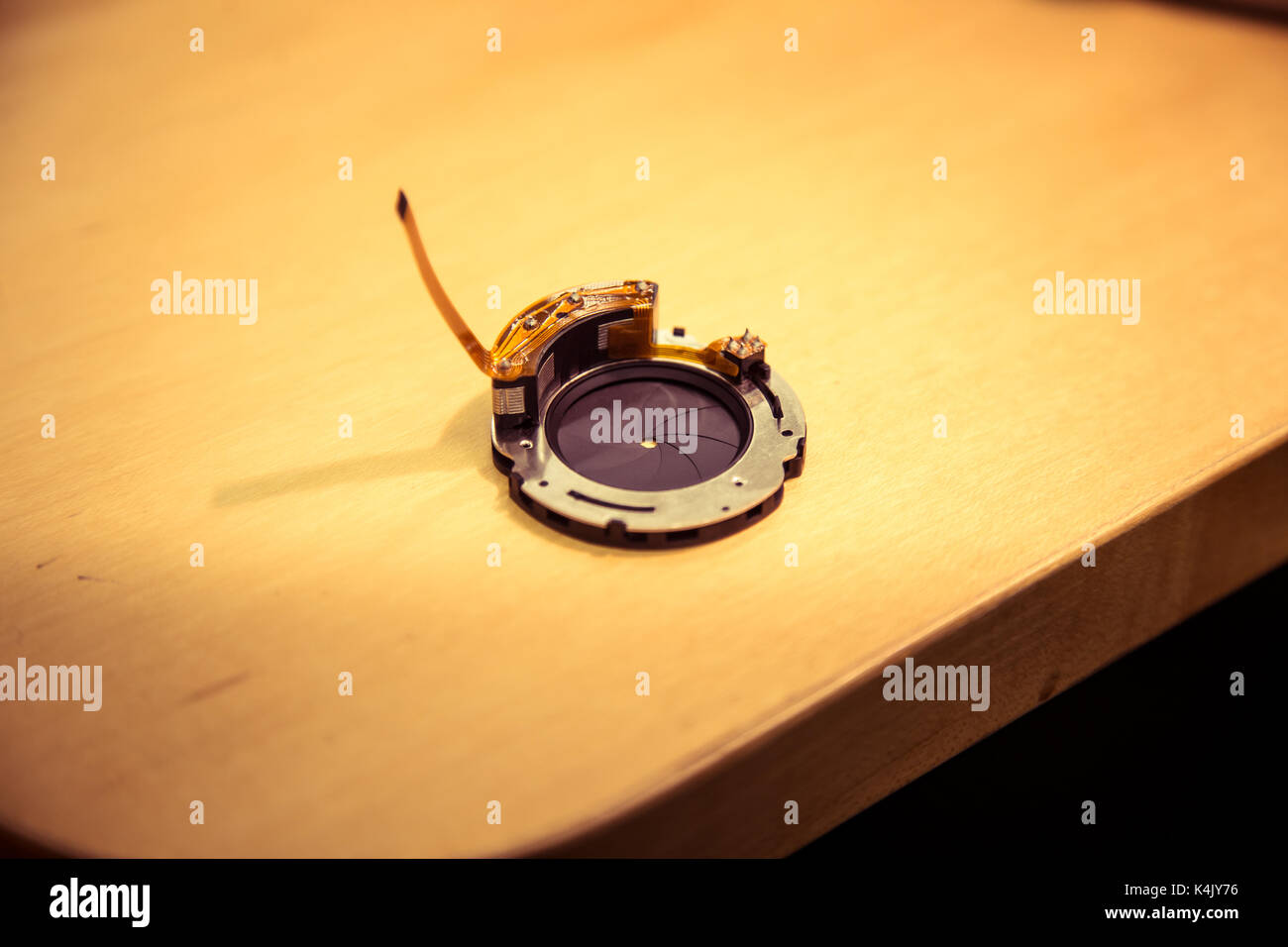 A man fixing photo camera lens on an office table Stock Photo - Alamy