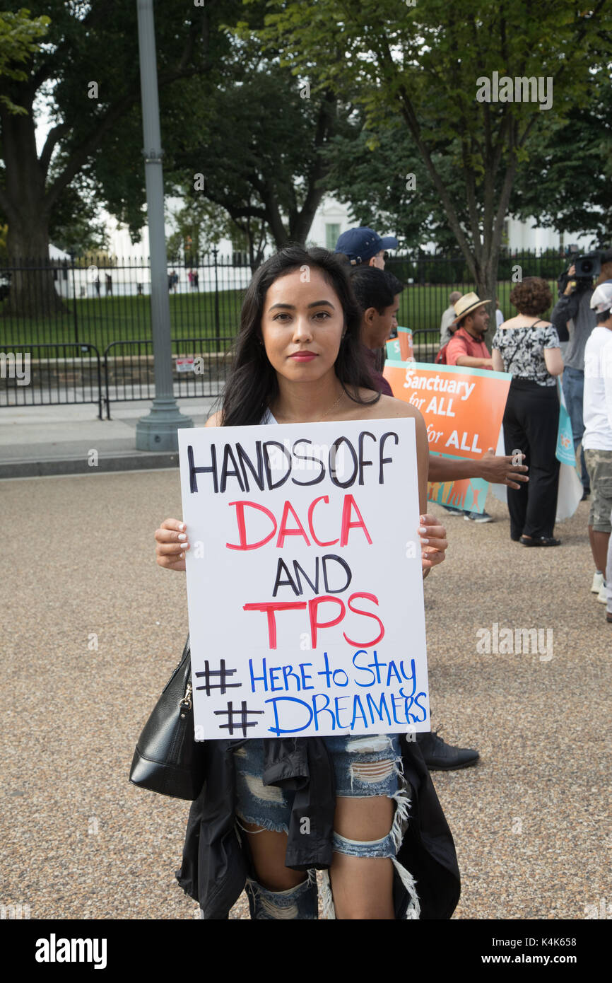 "Hands off DACA and TPS (Temporary Protective Status)" reads the sign ...