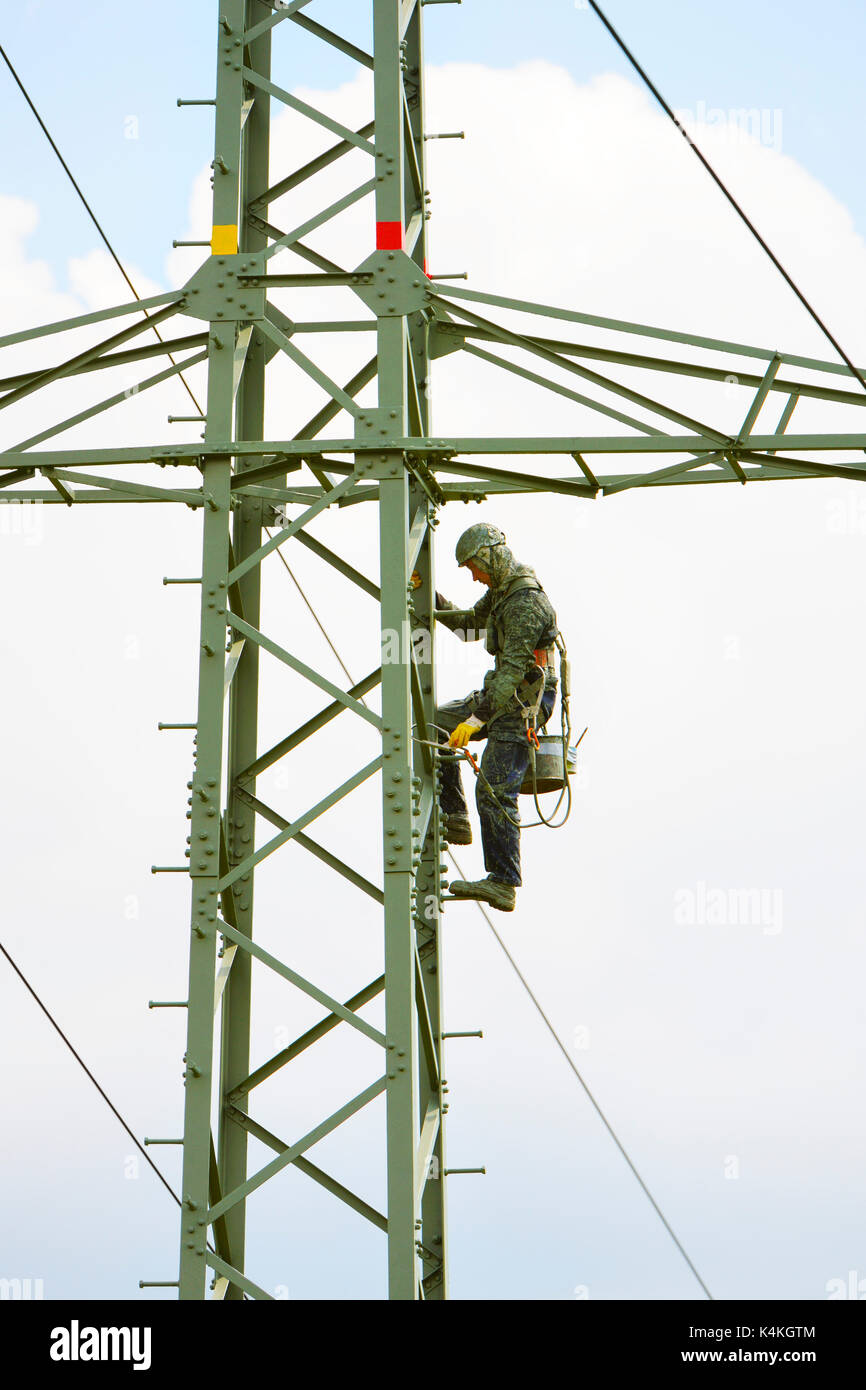 Painter on high voltage pylon hi-res stock photography and images - Alamy