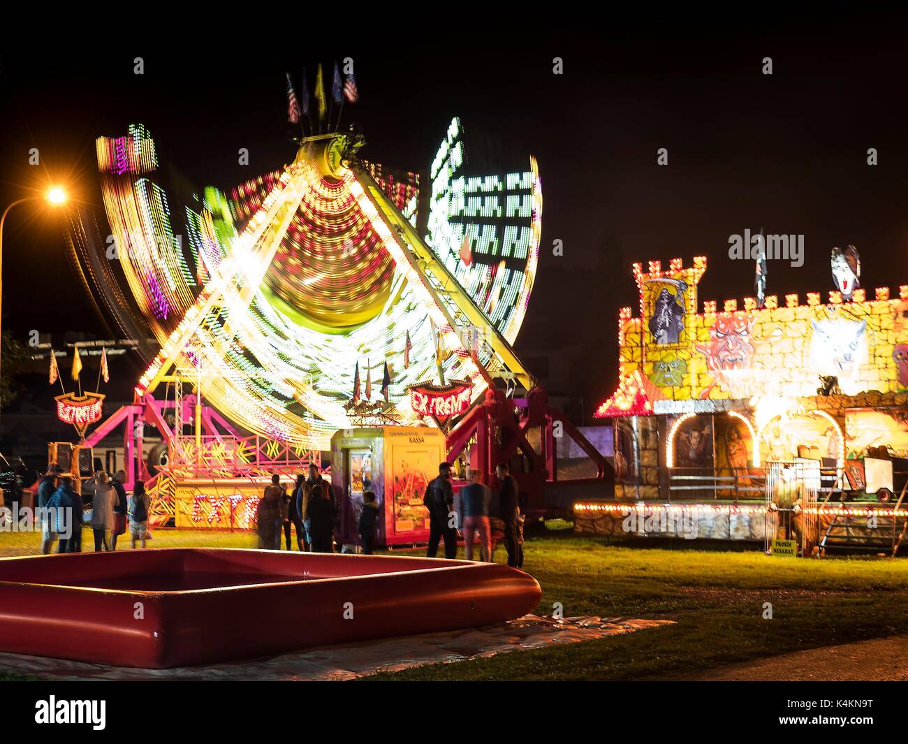 Fair, attraction, pendulum, scary castle, night Stock Photo - Alamy