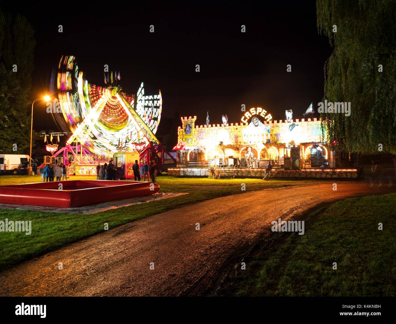 Fair, attraction, pendulum, scary castle, night Stock Photo - Alamy