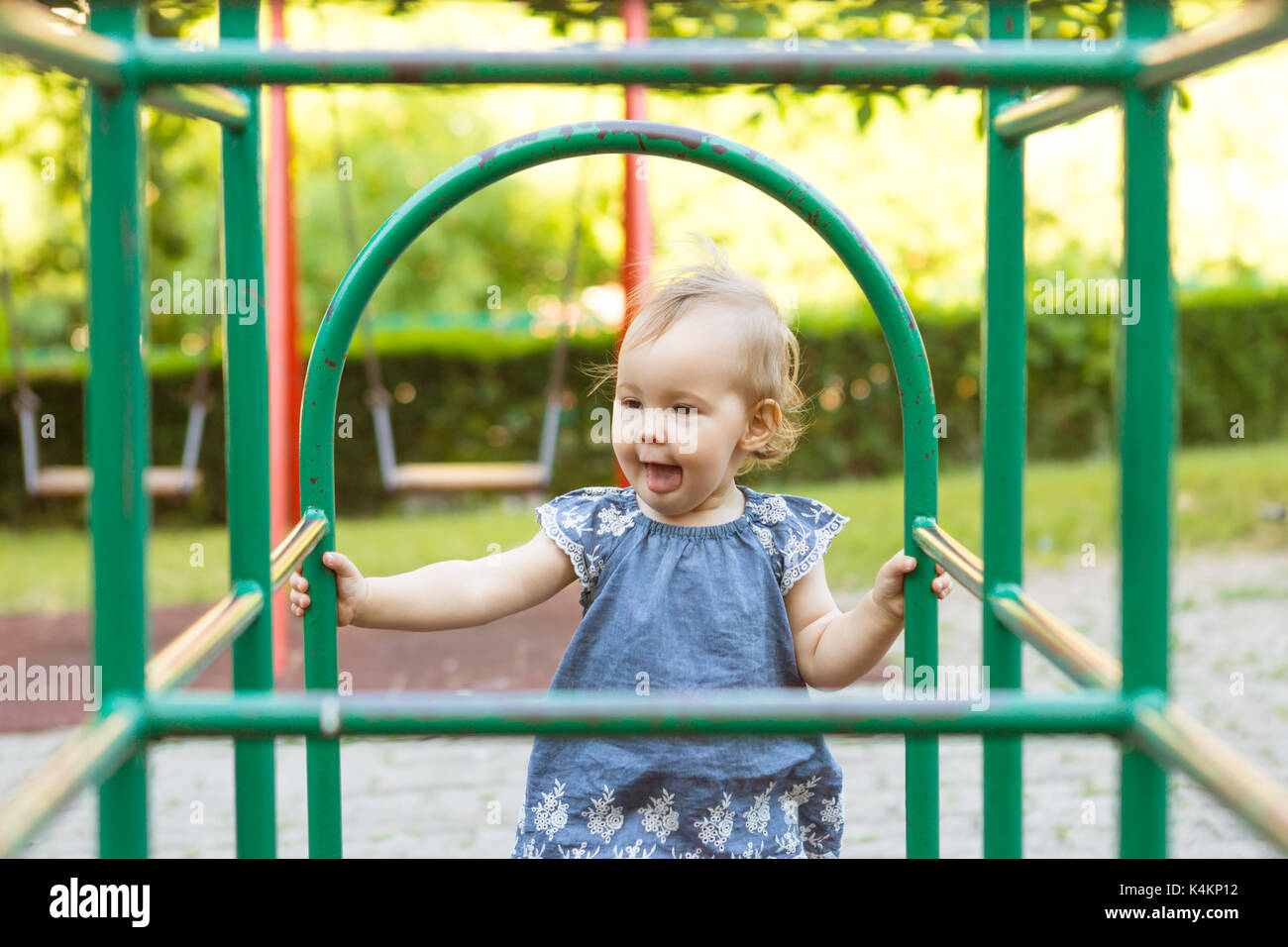 Baby girl playing on the children's playground Stock Photo - Alamy
