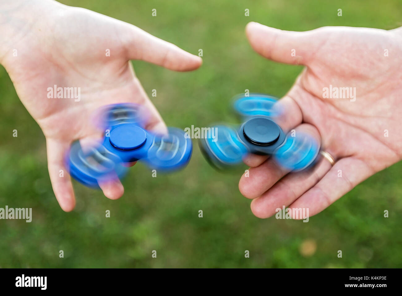 Father and daughter holding and spinning fidget spinners Stock Photo ...