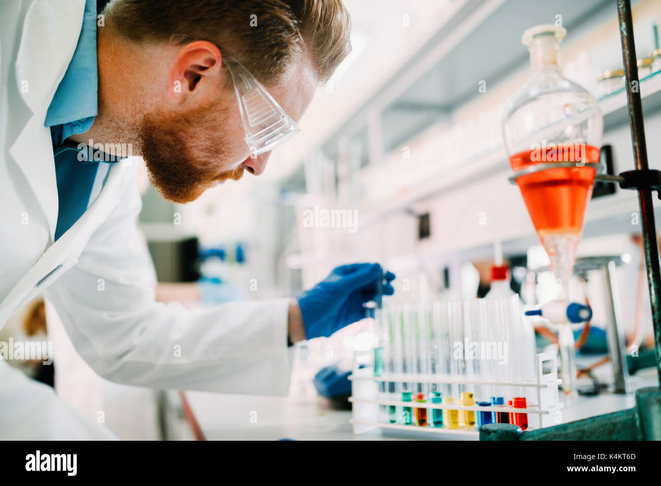 Handsome student of chemistry working in laboratory Stock Photo - Alamy