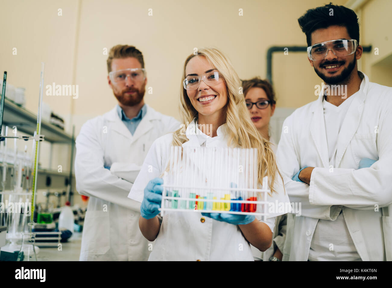 Group of young successful scientists posing for camera Stock Photo - Alamy