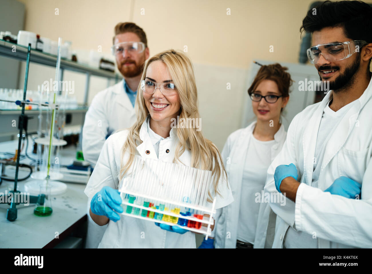 Group of young successful scientists posing for camera Stock Photo - Alamy