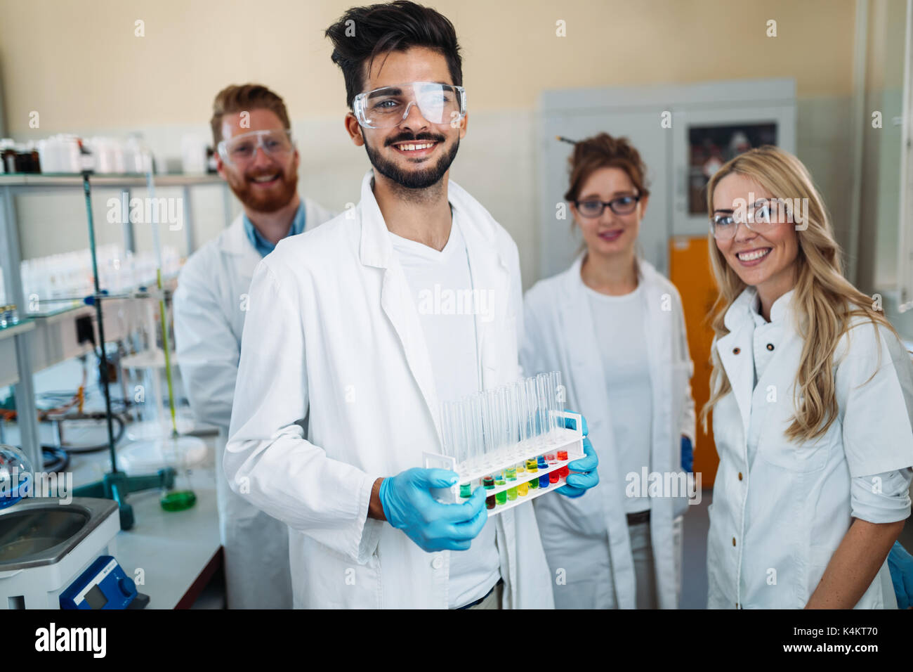 Group of young successful scientists posing for camera Stock Photo - Alamy