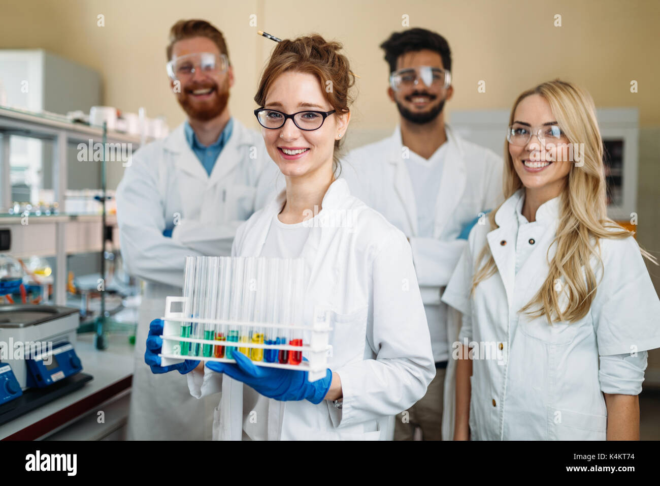 Group of young successful scientists posing for camera Stock Photo - Alamy