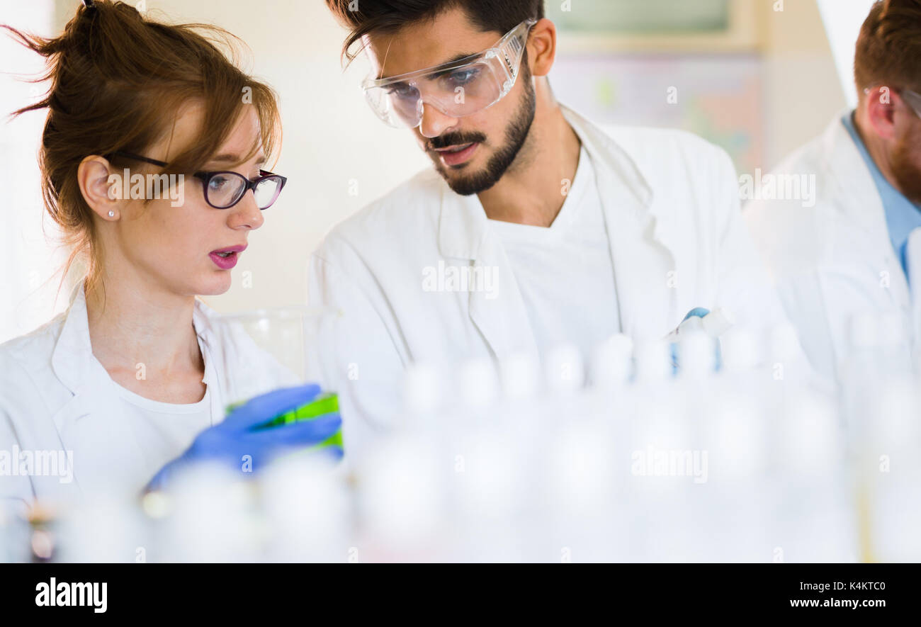 Young students of chemistry working in laboratory Stock Photo - Alamy