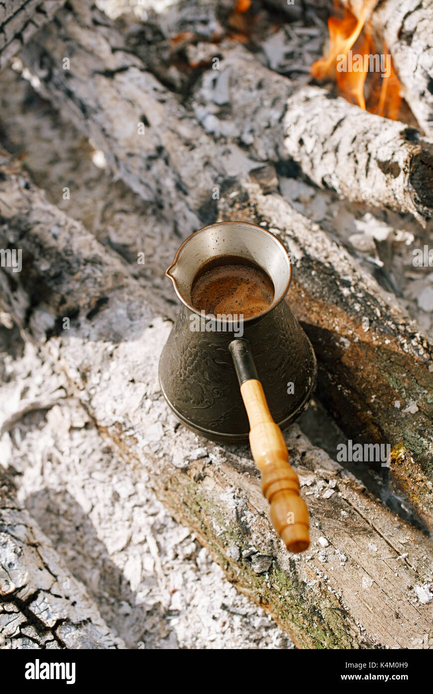 Making coffee in the fireplace on camping or hiking in the nature Stock ...