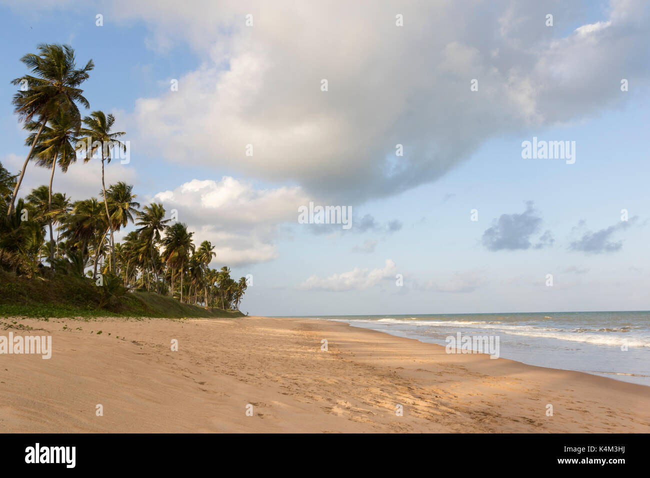 hot summer day on the beach with calm blue sea and waves with white ...