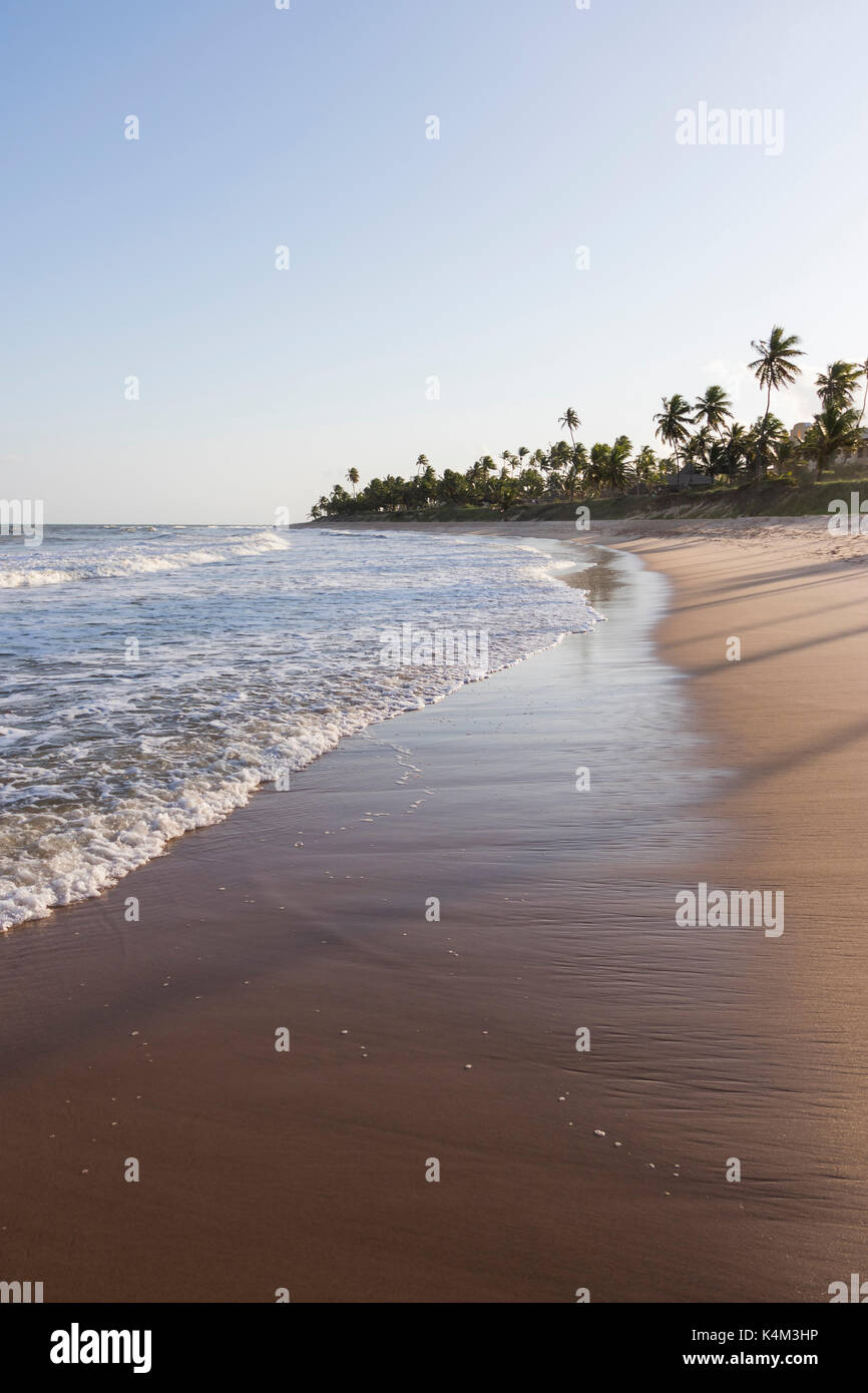 hot summer sunset on the beach with calm blue sea and waves with white ...