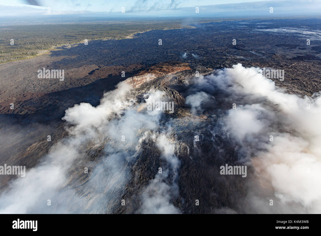 Aerial view of smoking caldera of active volcanoes on a mountaintop in ...