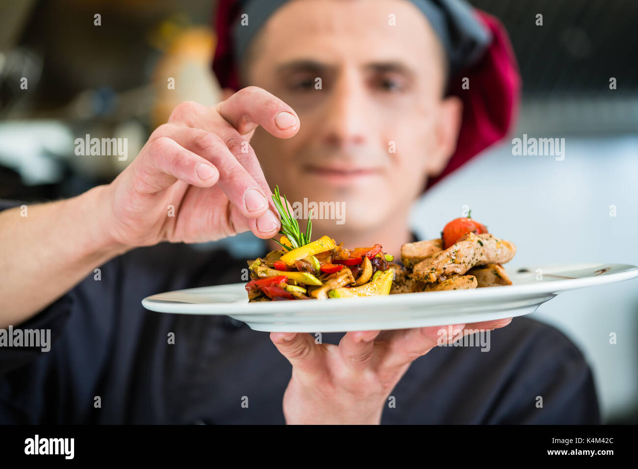 Chef showing proud food or dish he cooked Stock Photo - Alamy