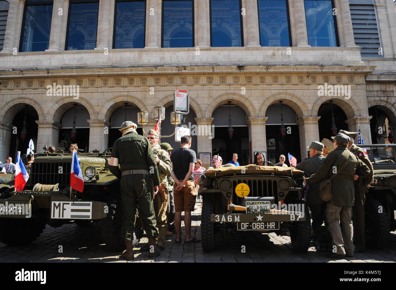 People dress up in US army uniform and military vehicles in front of ...