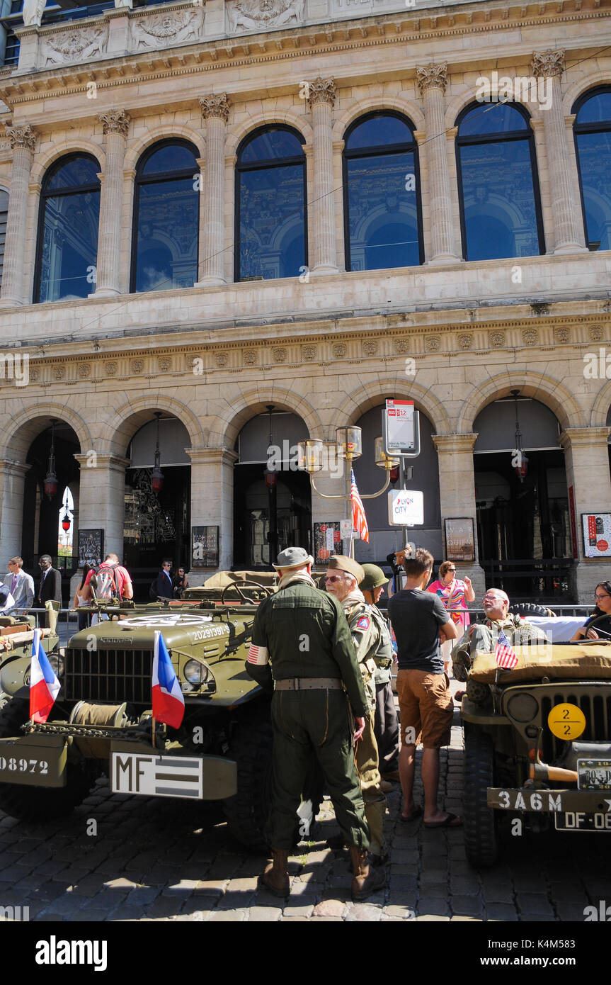 People dress up in US army uniform and military vehicles in front of ...