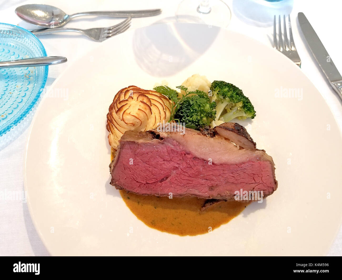 rare filet mignon steak with mashed potatoes and broccoli on white ...