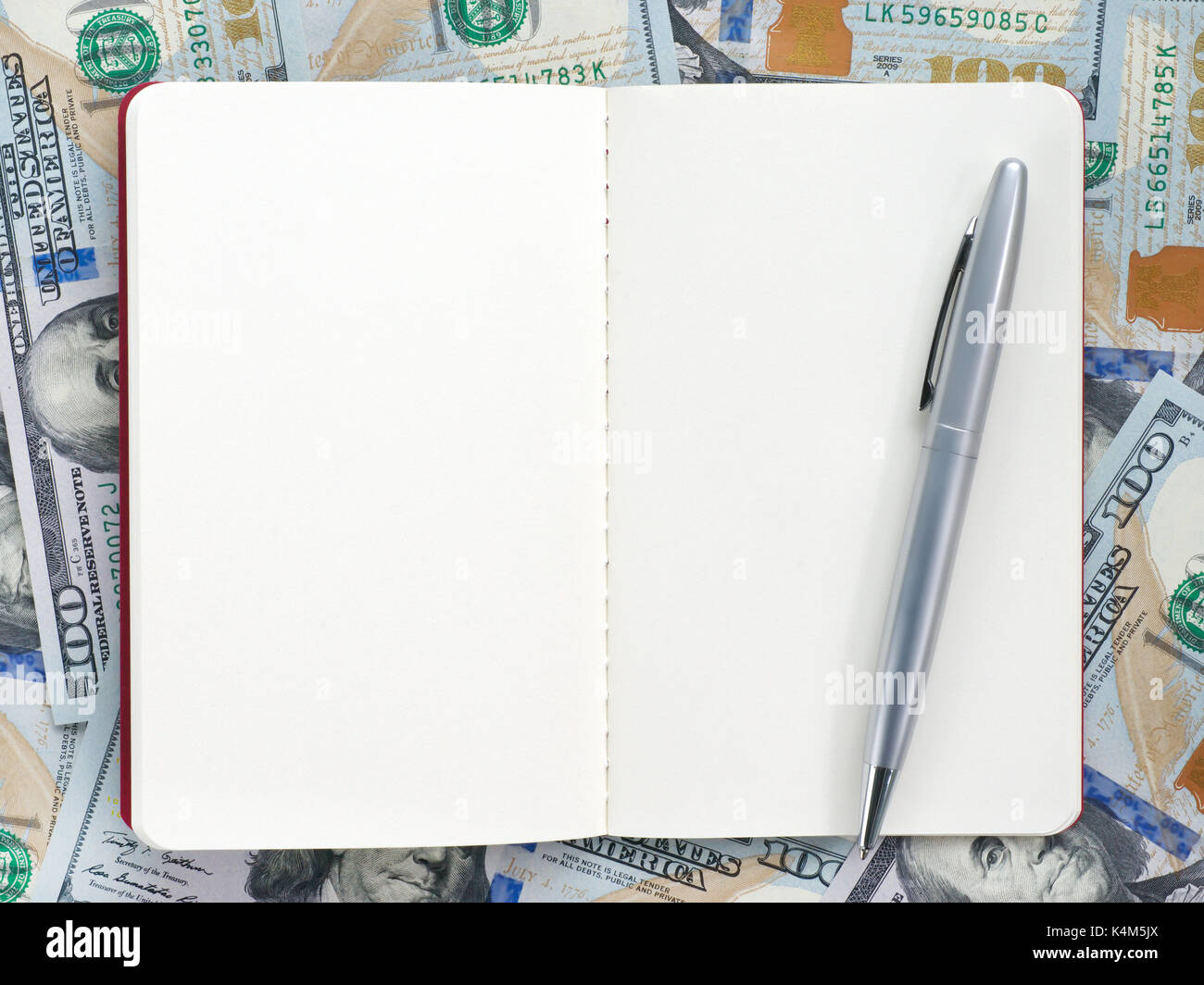 Open note with pen on dollar banknotes. Business and finance theme ...