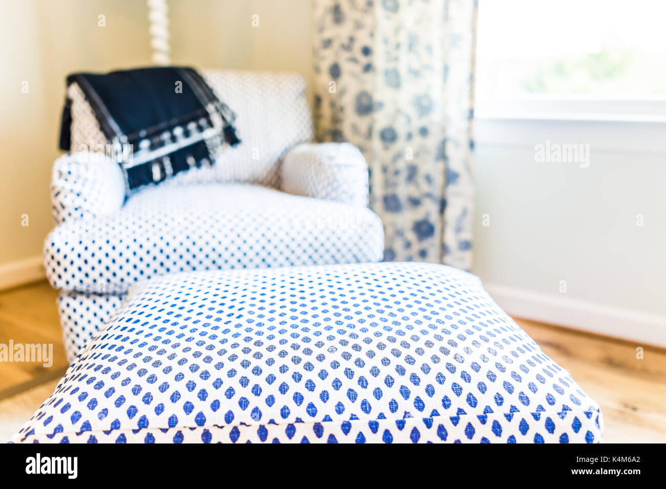 Closeup of new modern blue couch sofa by windows with natural light in ...