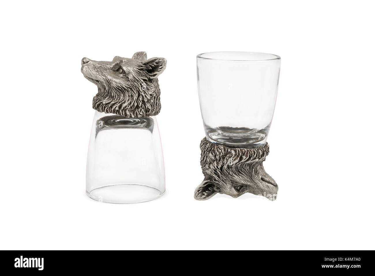 Set of two glasses for vodka with a wolf head on the bottom, isolated ...