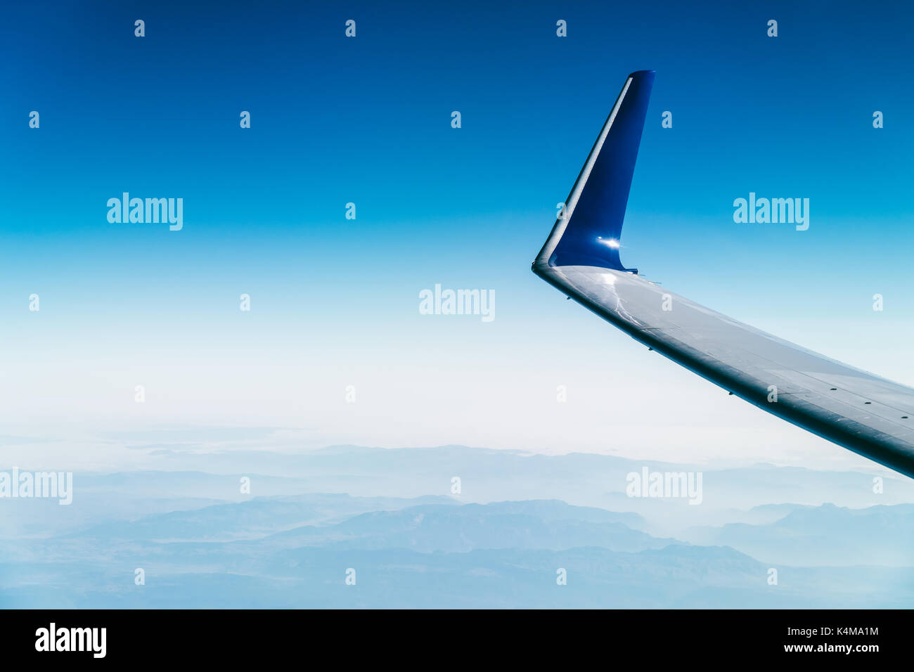 Airplane Wing View Above The Clouds Stock Photo - Alamy