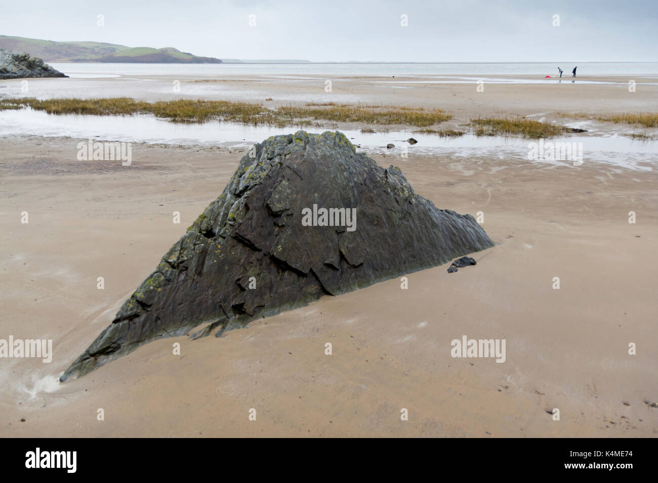 Sharp rock jutting out of a North Wales beach Stock Photo - Alamy