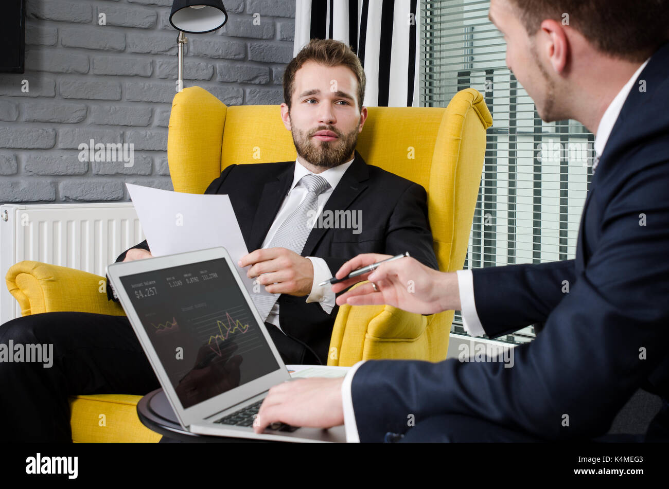 Two focused business partners talking in a modern office Stock Photo ...