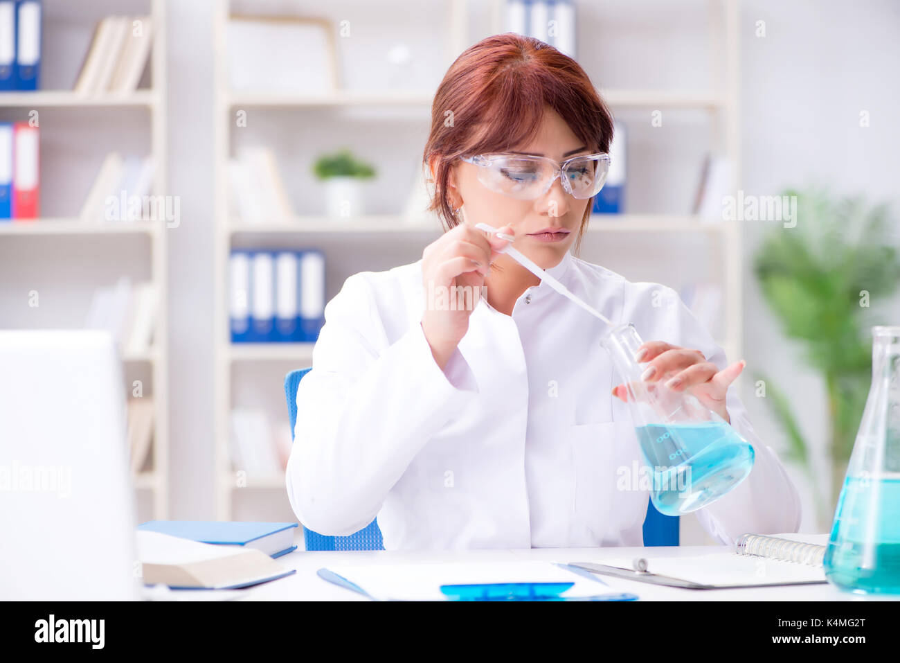 Female scientist researcher conducting an experiment in a laboratory ...