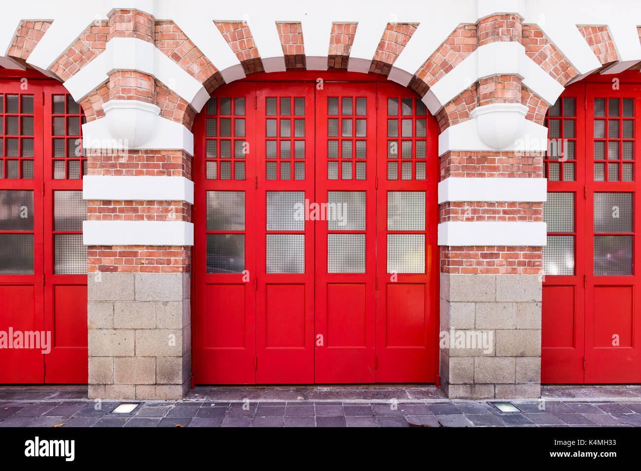 Huge red gate for entrance to building Stock Photo - Alamy