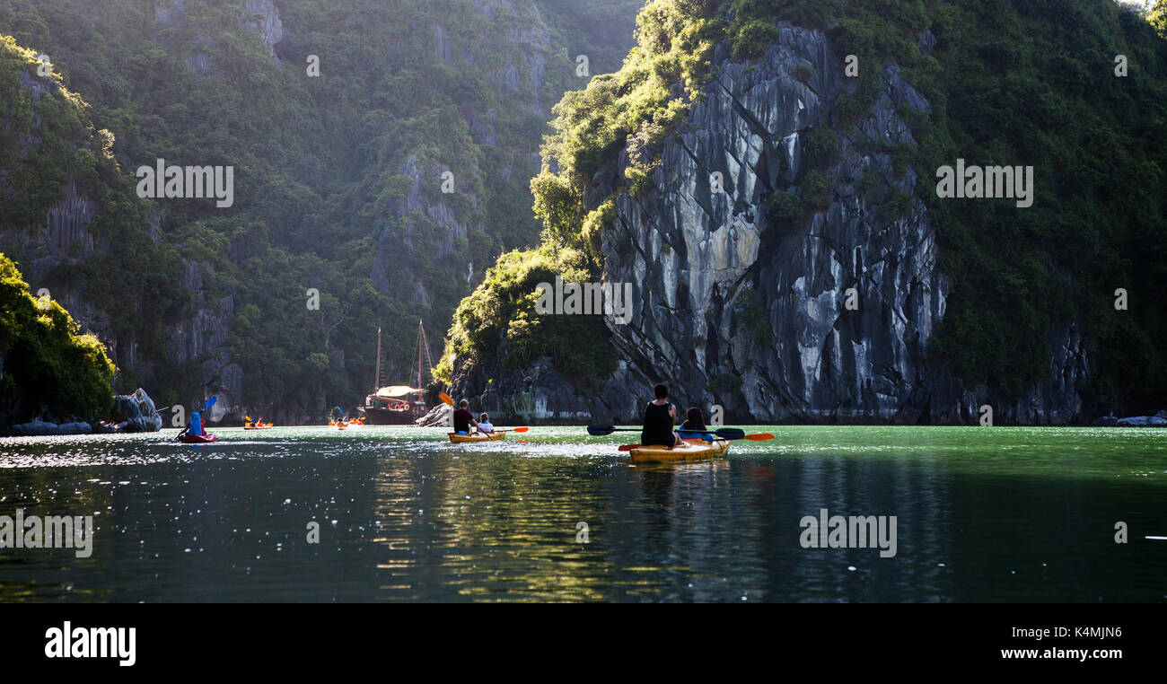 kayaking among caves and lagoon in Ha Long bay, UNESCO world heritage ...