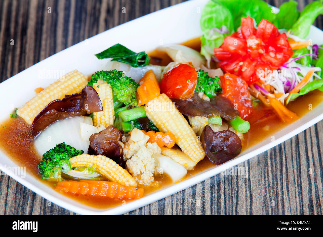 Fried mixed vegetable on white plate, close up Stock Photo - Alamy
