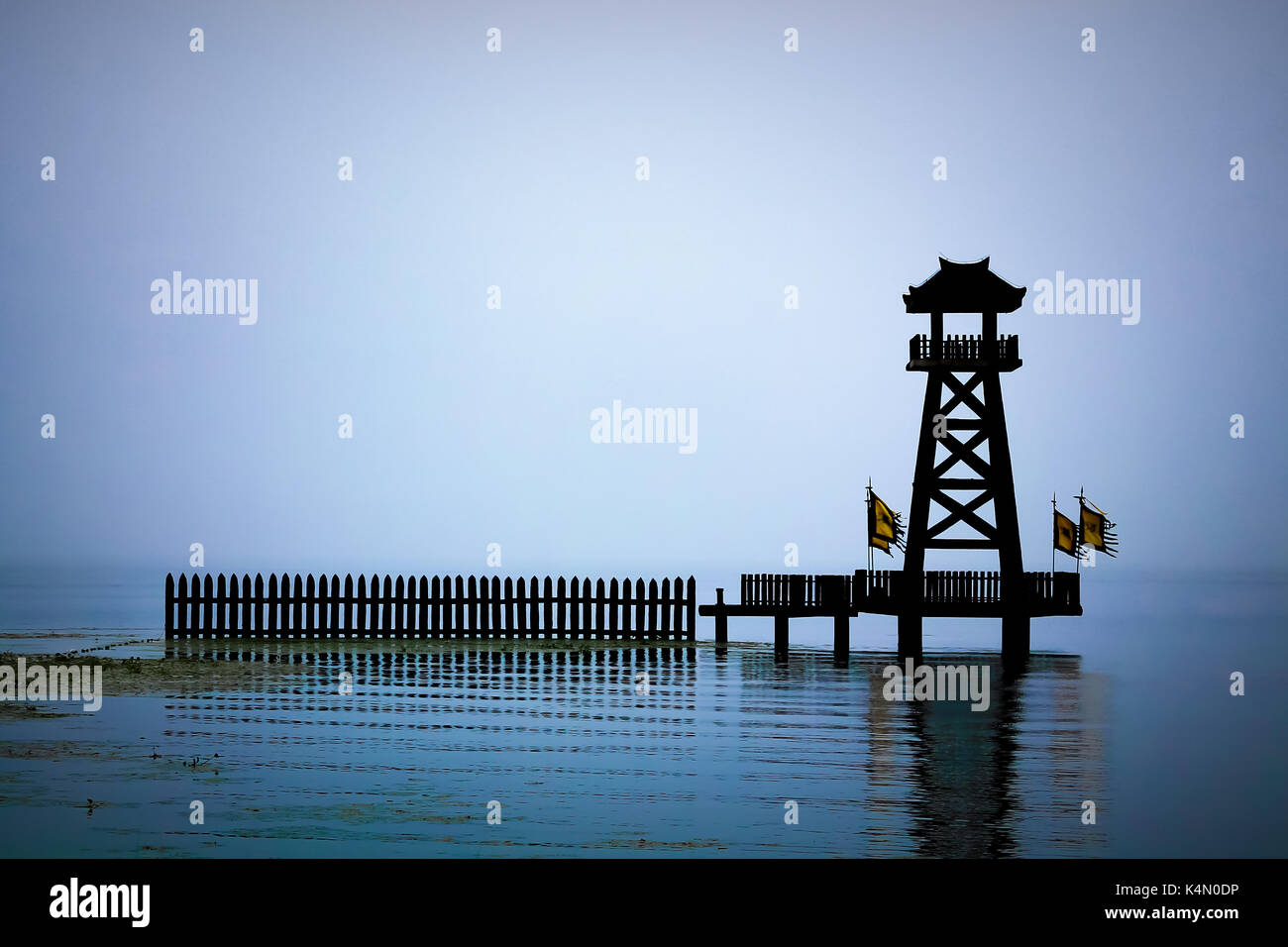 Chinese watchtower on a misty lake Stock Photo - Alamy