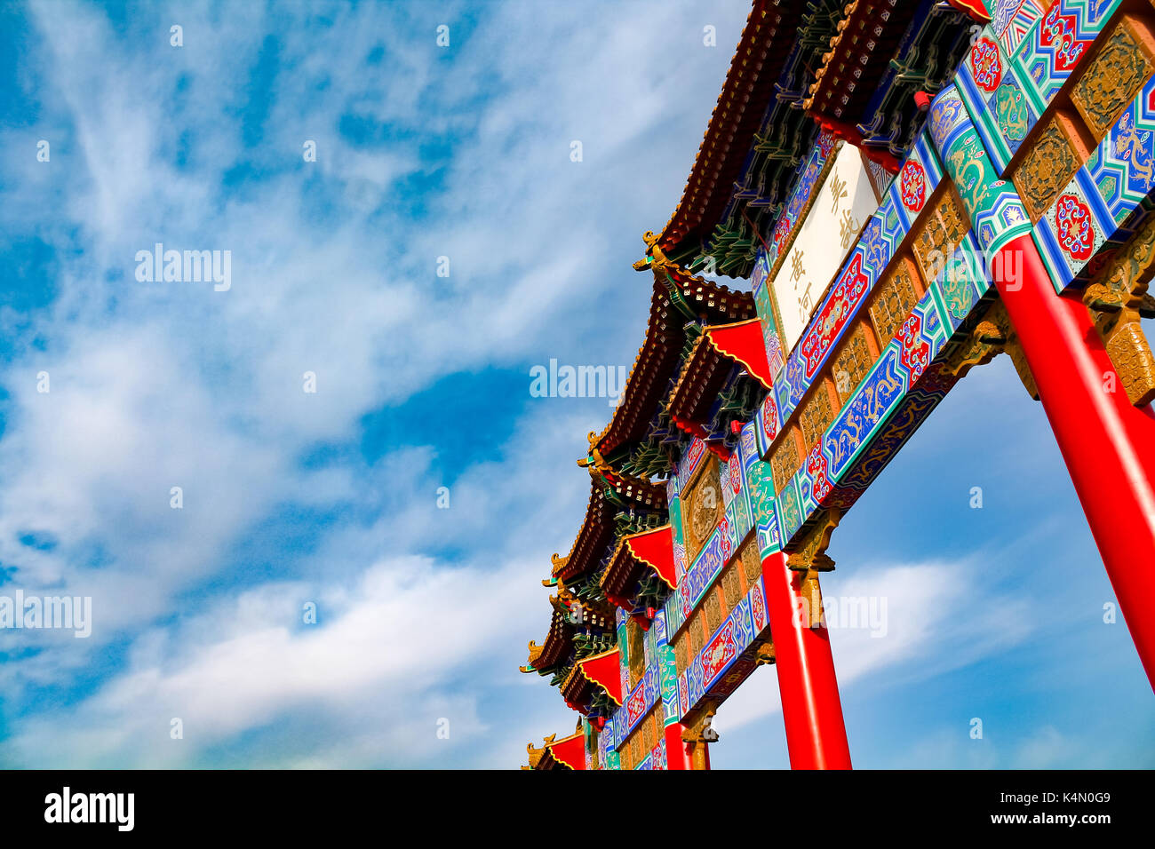 A Chinese paifang gate with blue sky in the background Stock Photo - Alamy