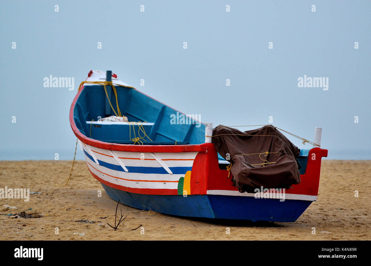 Traditional boat on sand beach, India Stock Photo - Alamy