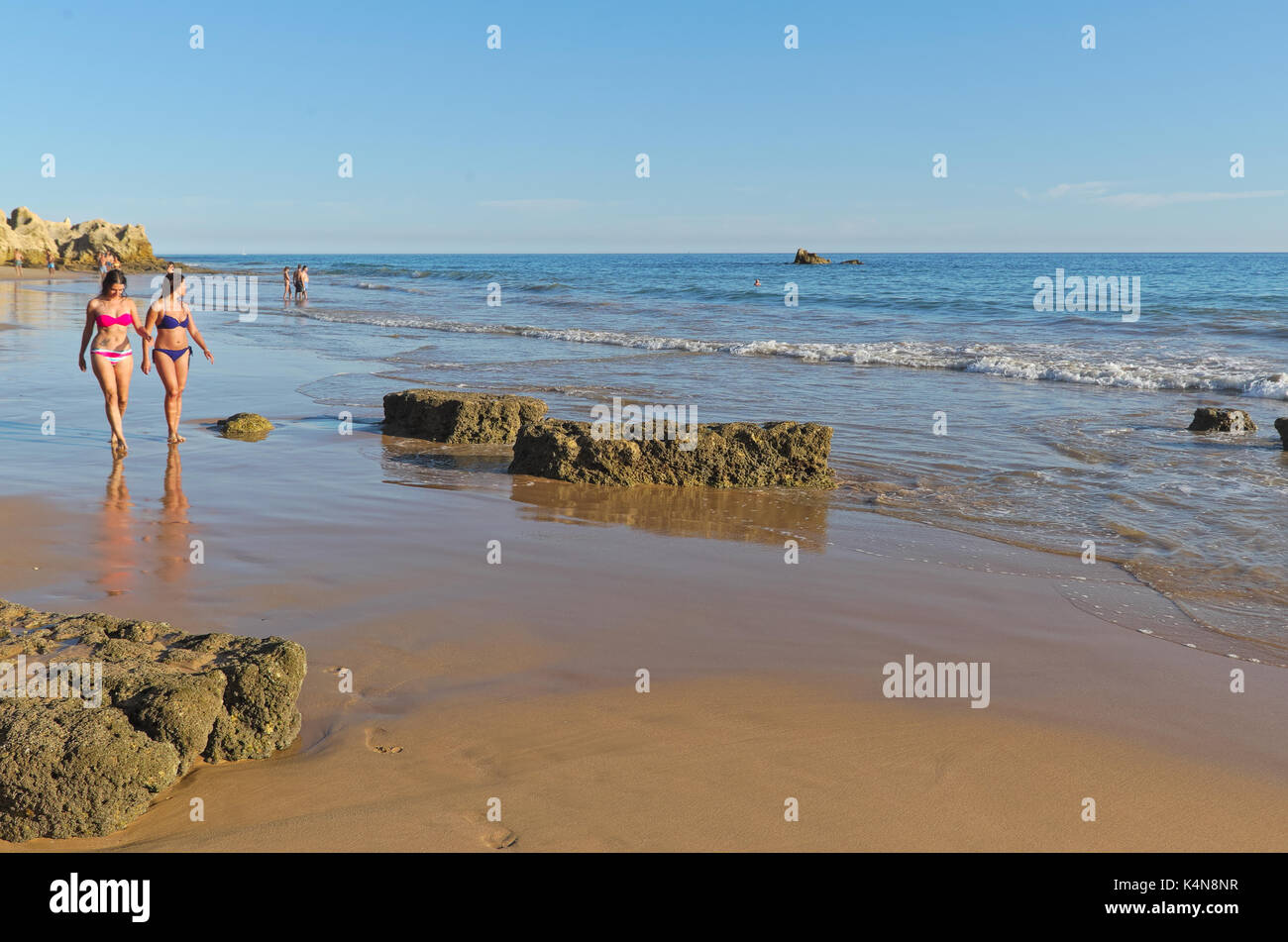 Two young women walking by the Gale beach in Albufeira. Portugal Stock ...