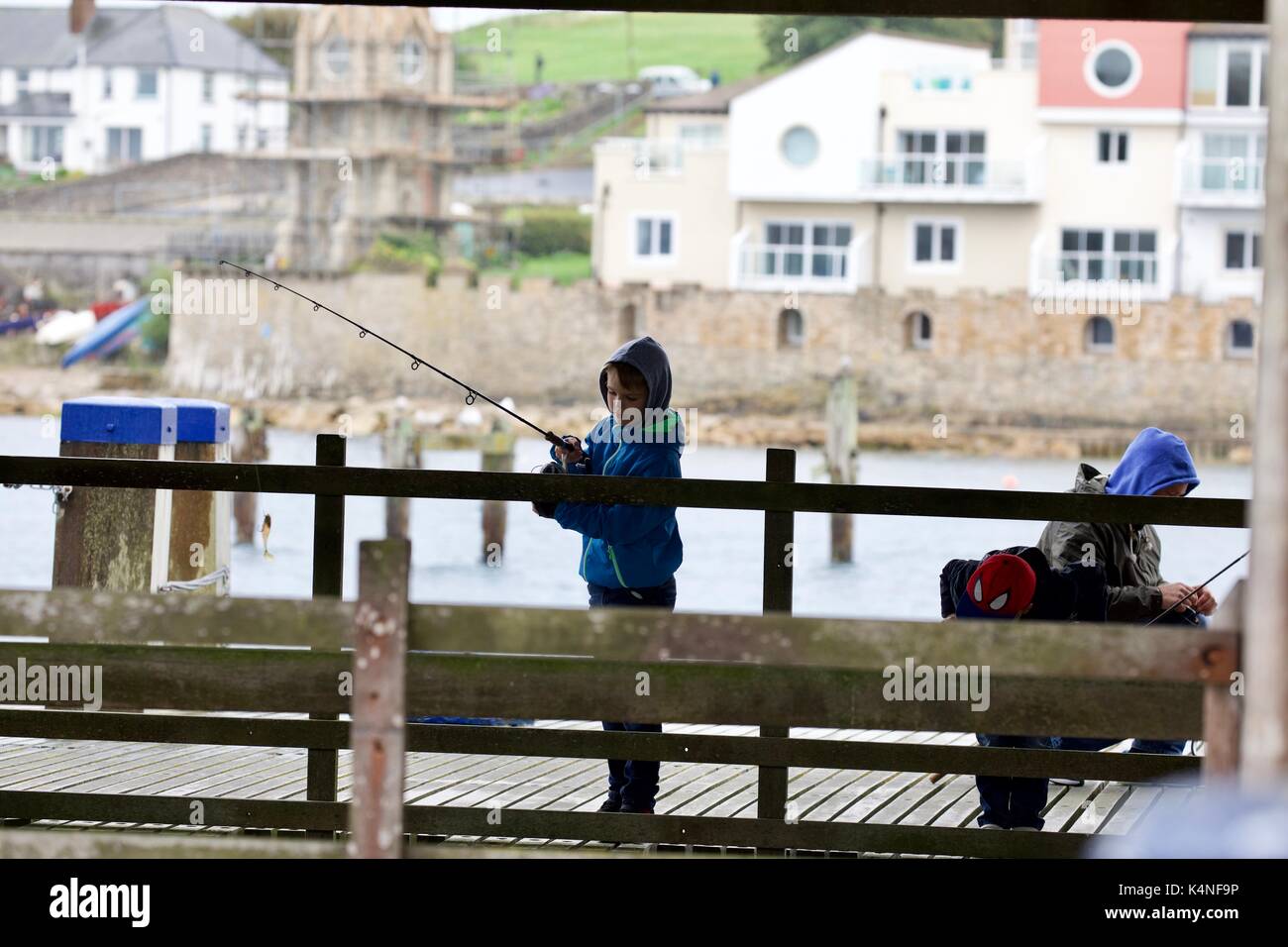 Father and his two sons fishing Stock Photo - Alamy