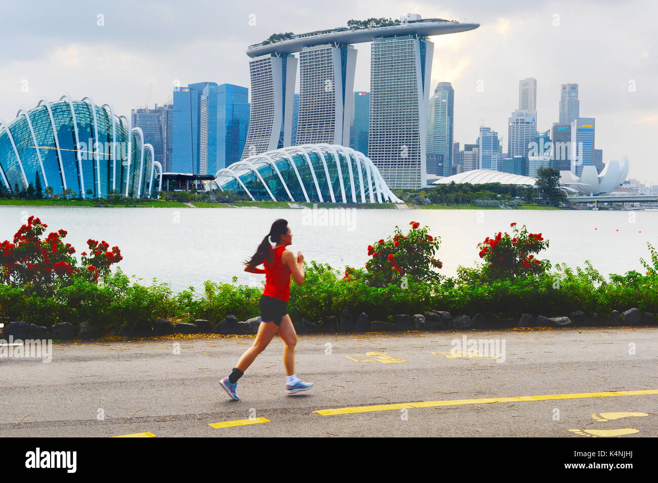 SINGAPORE - FEB 16, 2017: Beautiful young chinese woman running in ...