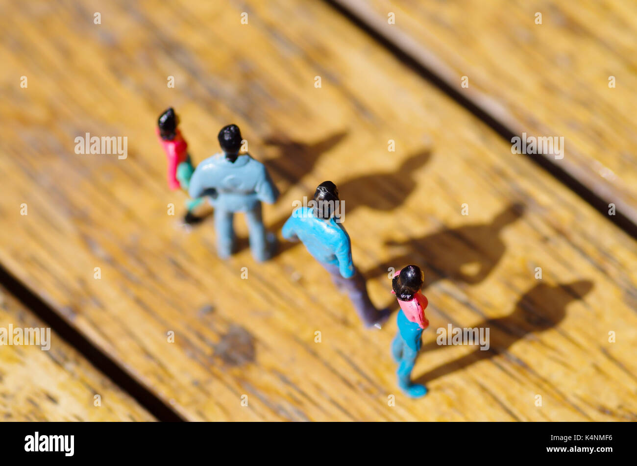 Miniature little people, friend at outdoors with shadow in the floor ...
