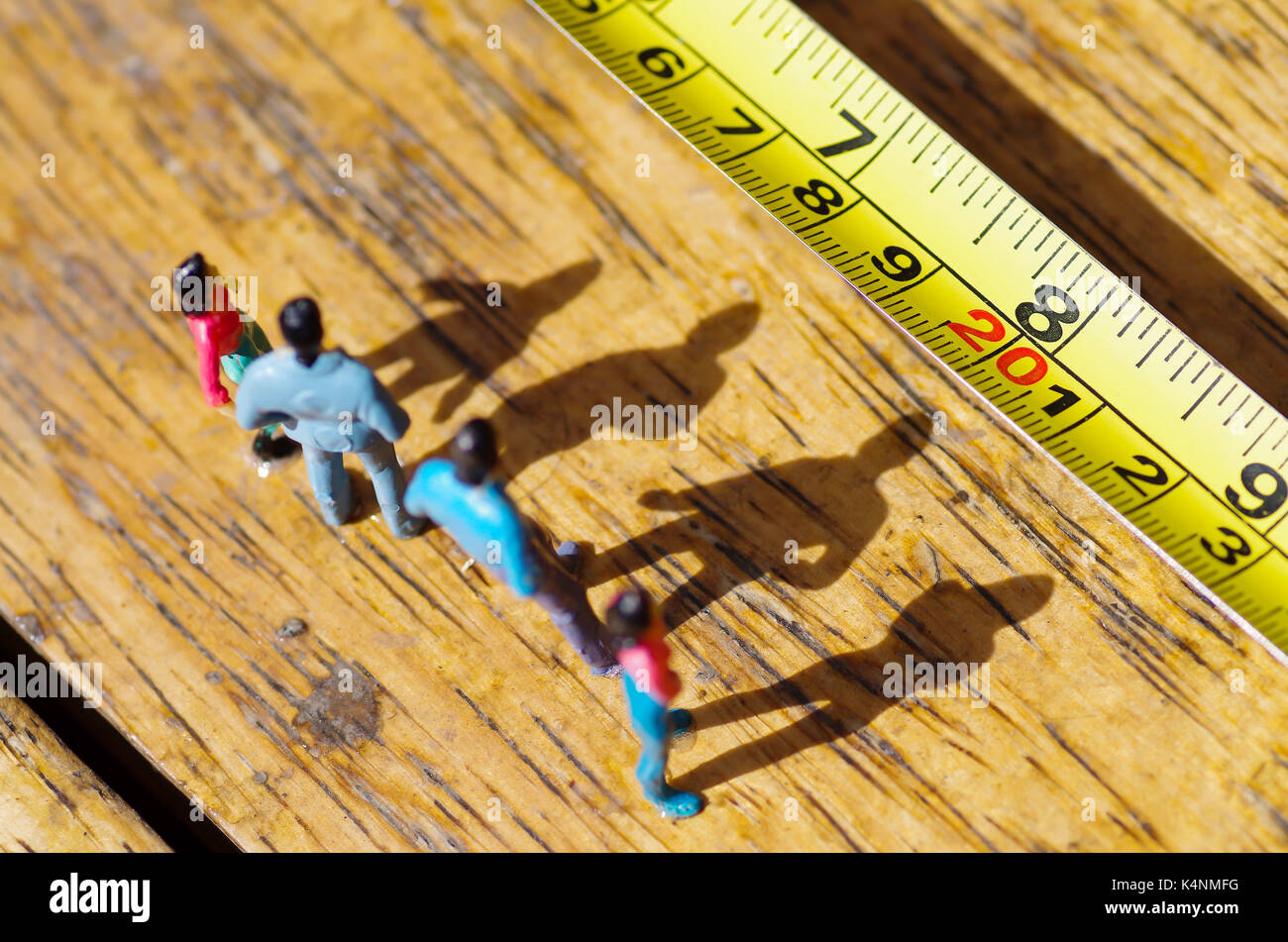 Miniature little people at outdoors with shadow in the floor, in front ...