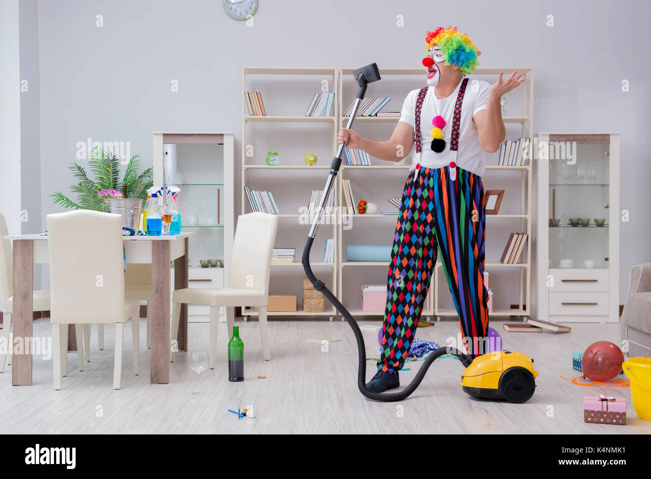 Funny clown doing cleaning at home Stock Photo - Alamy